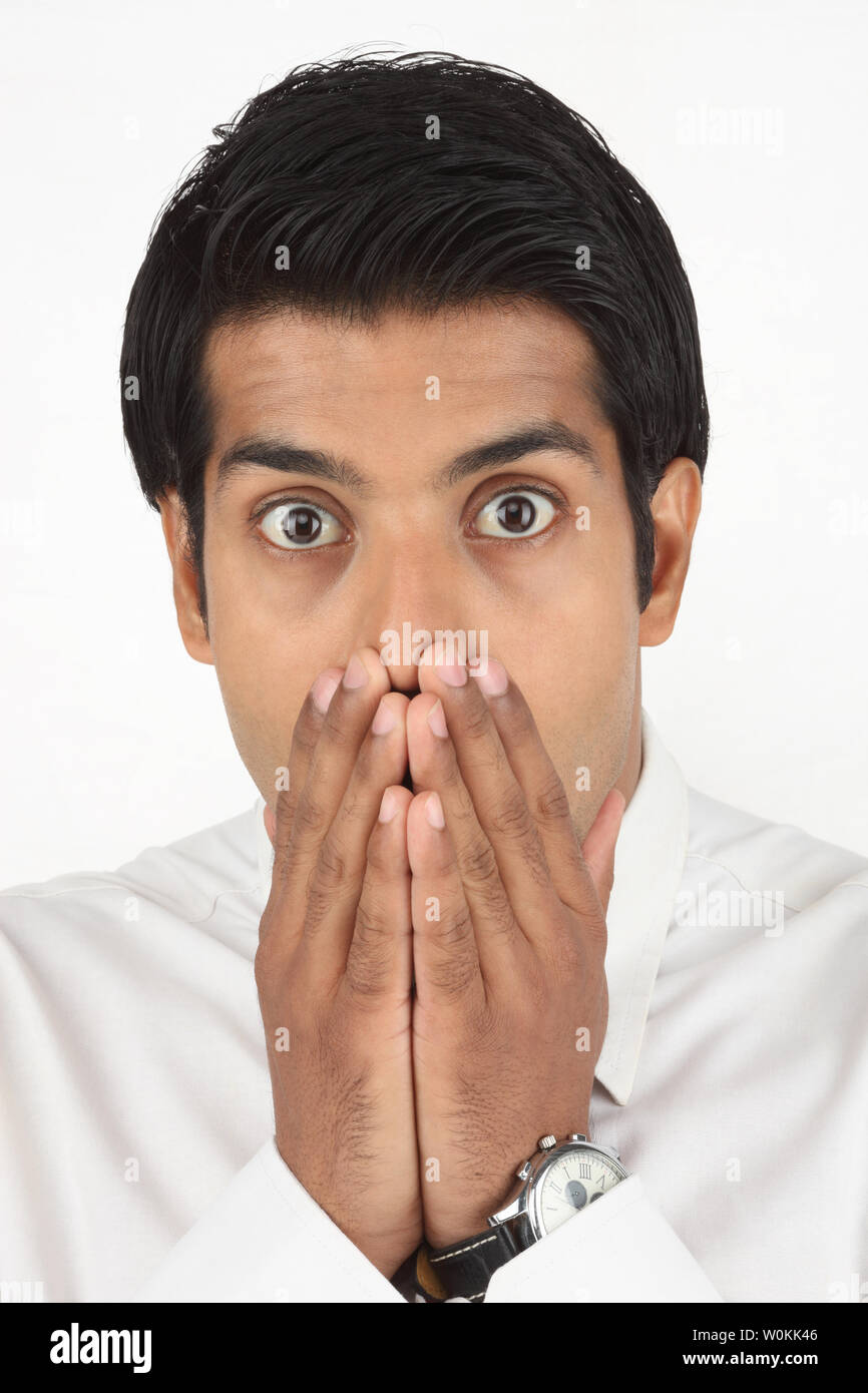 Indian young businessman looking shocked Stock Photo - Alamy