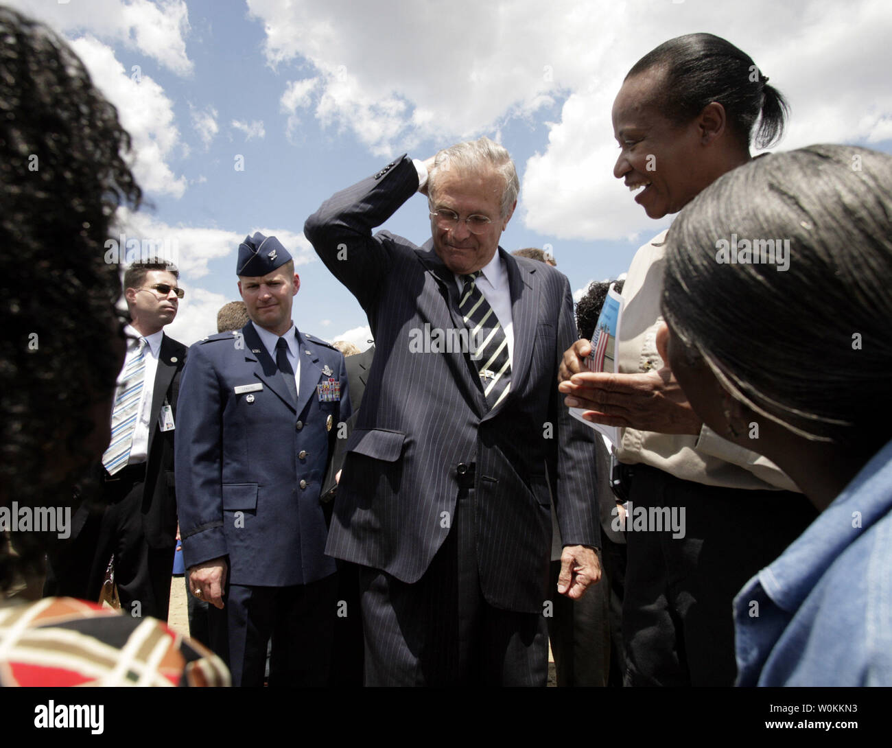 U.S. Defense Secretary Donald H. Rumsfeld (C) speaks with family ...