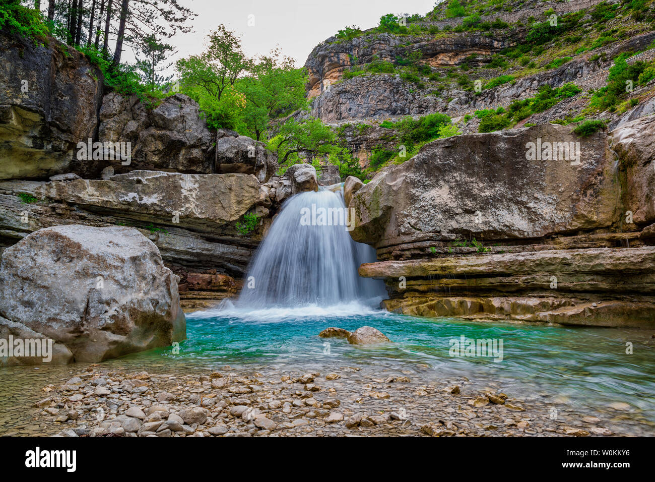 Alpine waterfall with emerald blue water. Provence, France Stock Photo ...