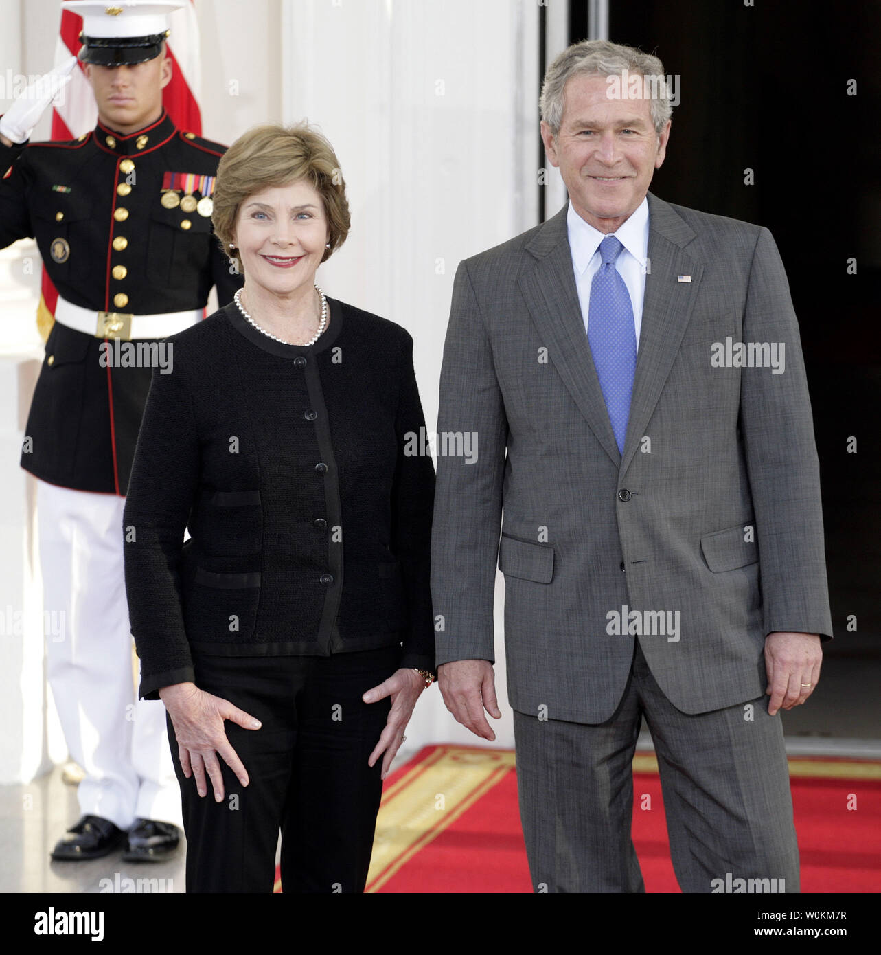 U.S. President George W. Bush and first lady Laura Bush wait Britain's ...