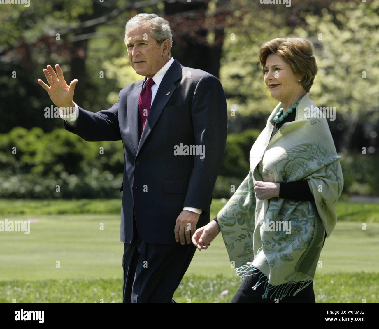 U.S. President George W. Bush and first lady Laura Bush walk from the ...