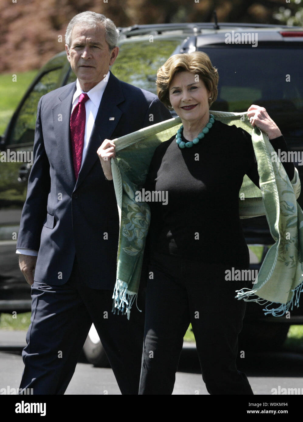 U.S. President George W. Bush and first lady Laura Bush walk from the ...