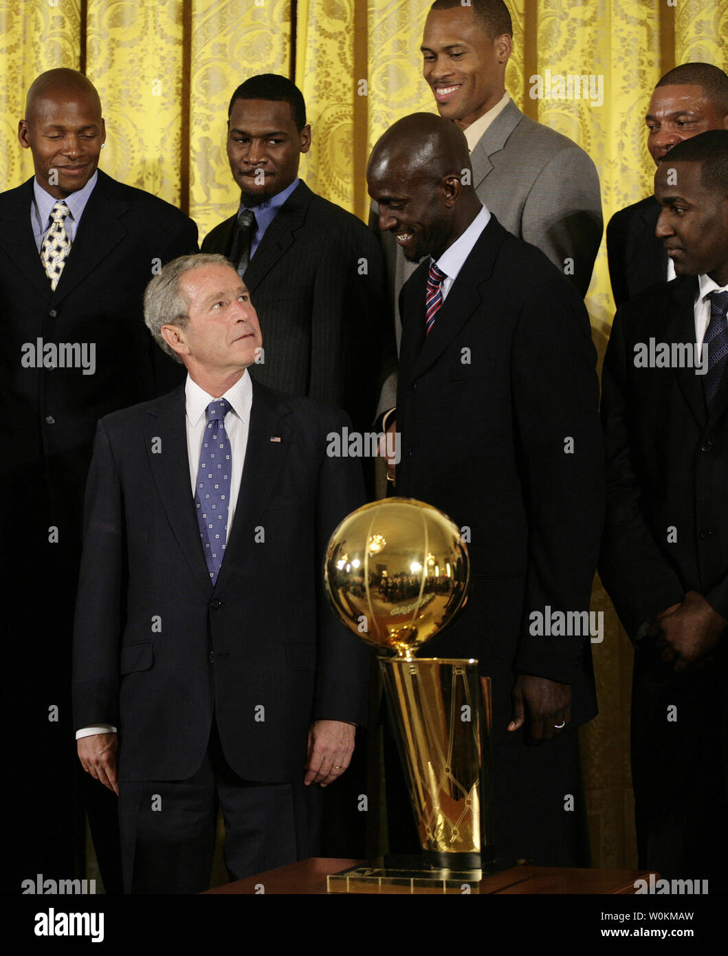U.S. President George W. Bush (C) looks on the players of NBA ...