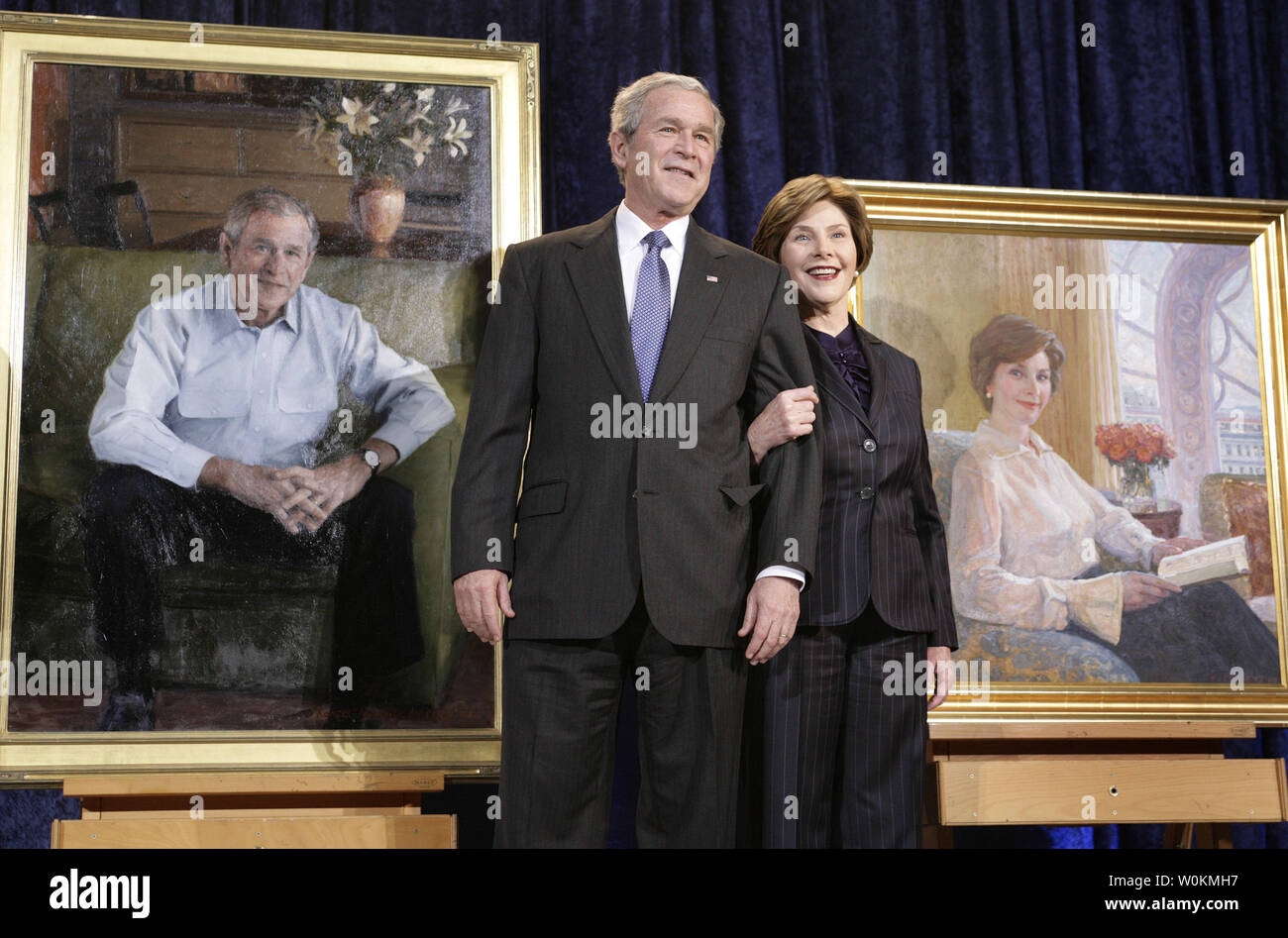 U.S. President George W. Bush and First Lady Laura Bush stand next to ...
