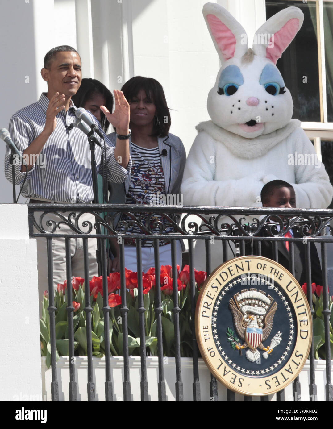 U.S. President Barack Obama speaks next to first lady Michelle Obama ...