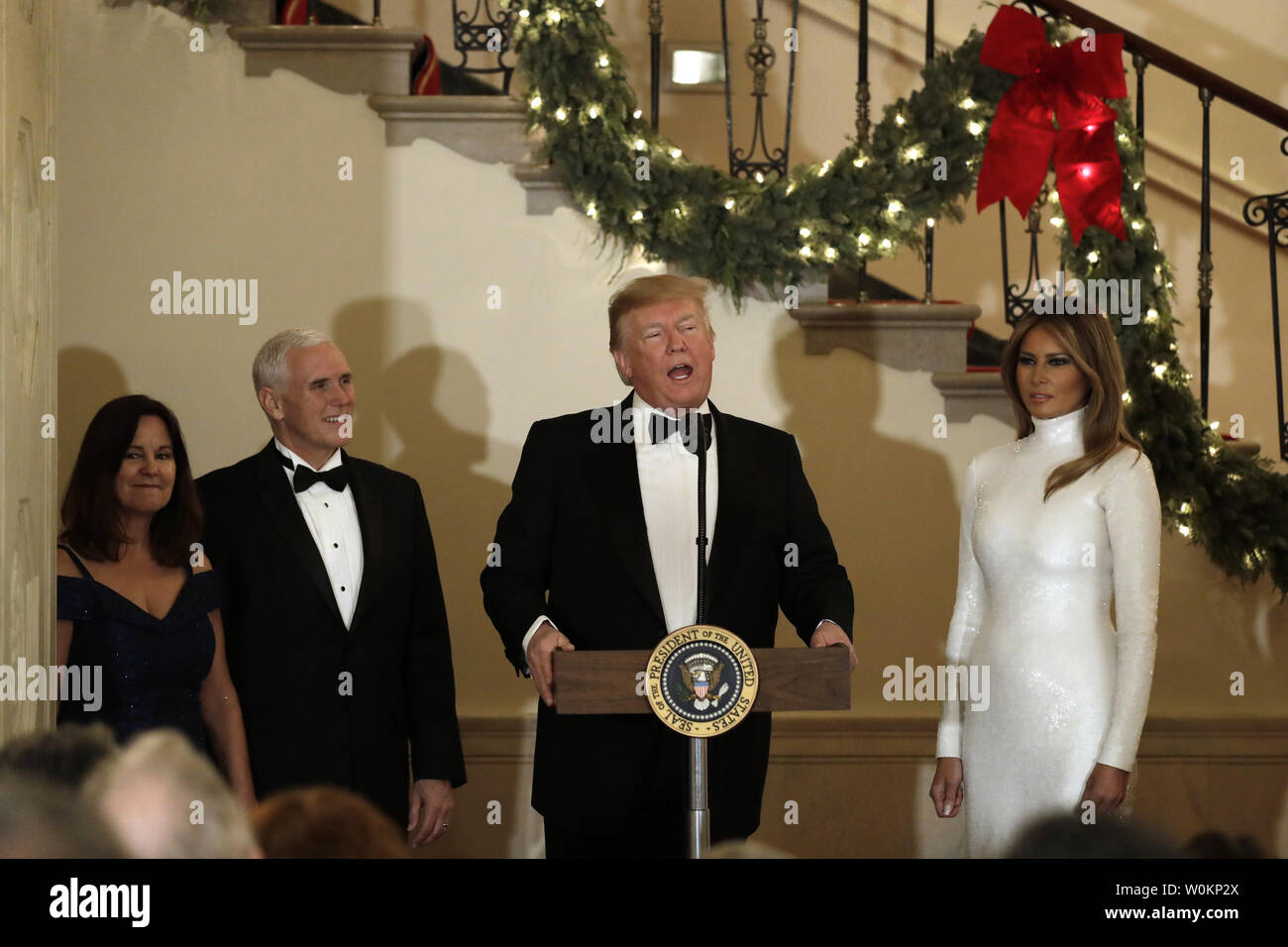 U.S. President Donald Trump speaks between First Lady Melania Trump and ...