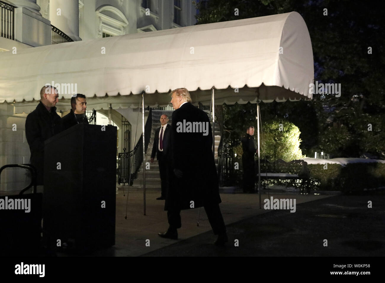 U.S. President Donald Trump enters the White House upon his return to ...
