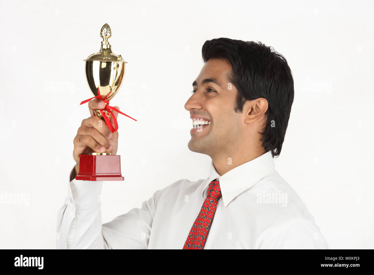 Close up smiling holding trophy achievement success hi-res stock ...