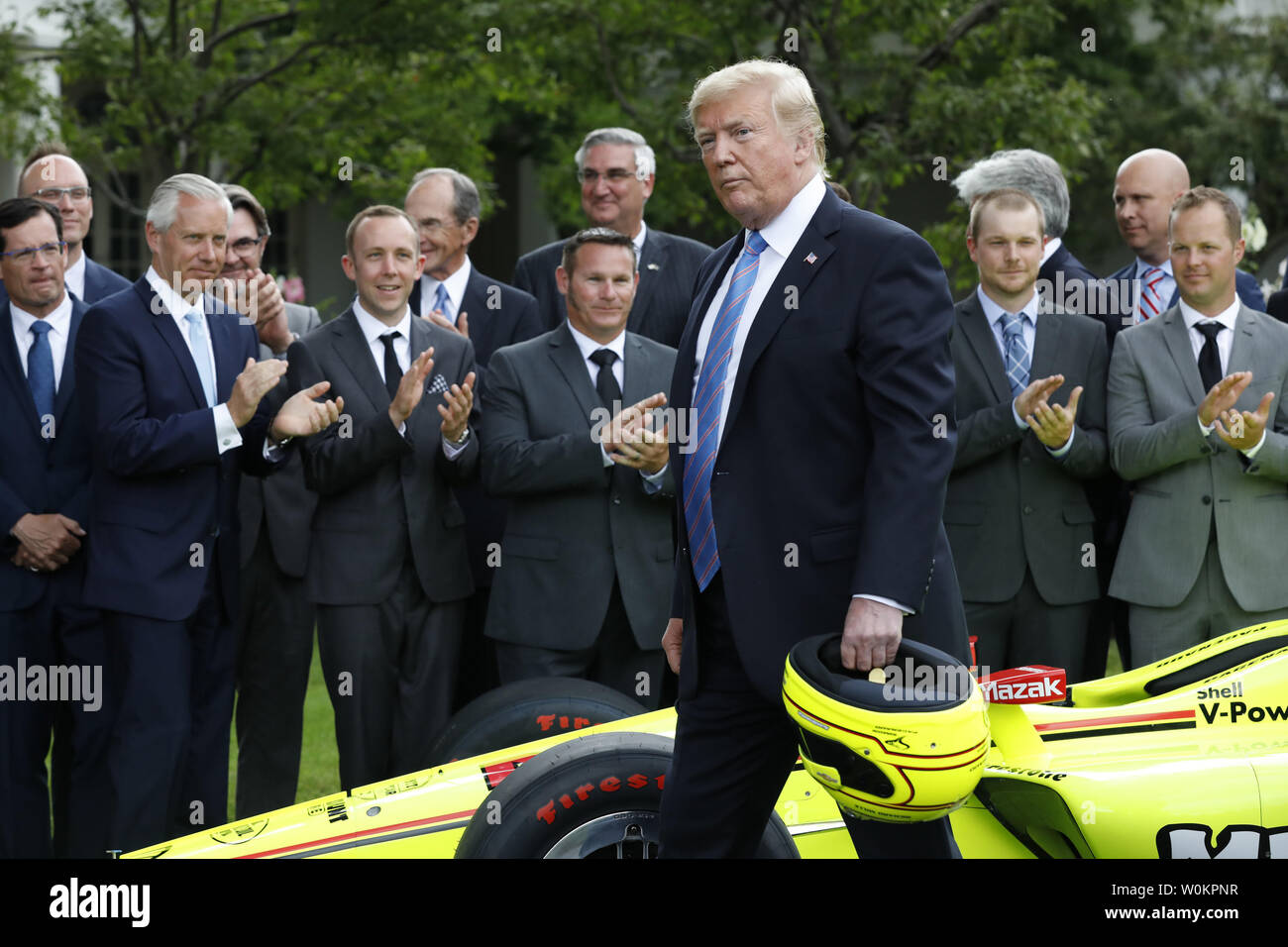 U.S. President Donald Trump holds a souvenir helmet presented him by ...
