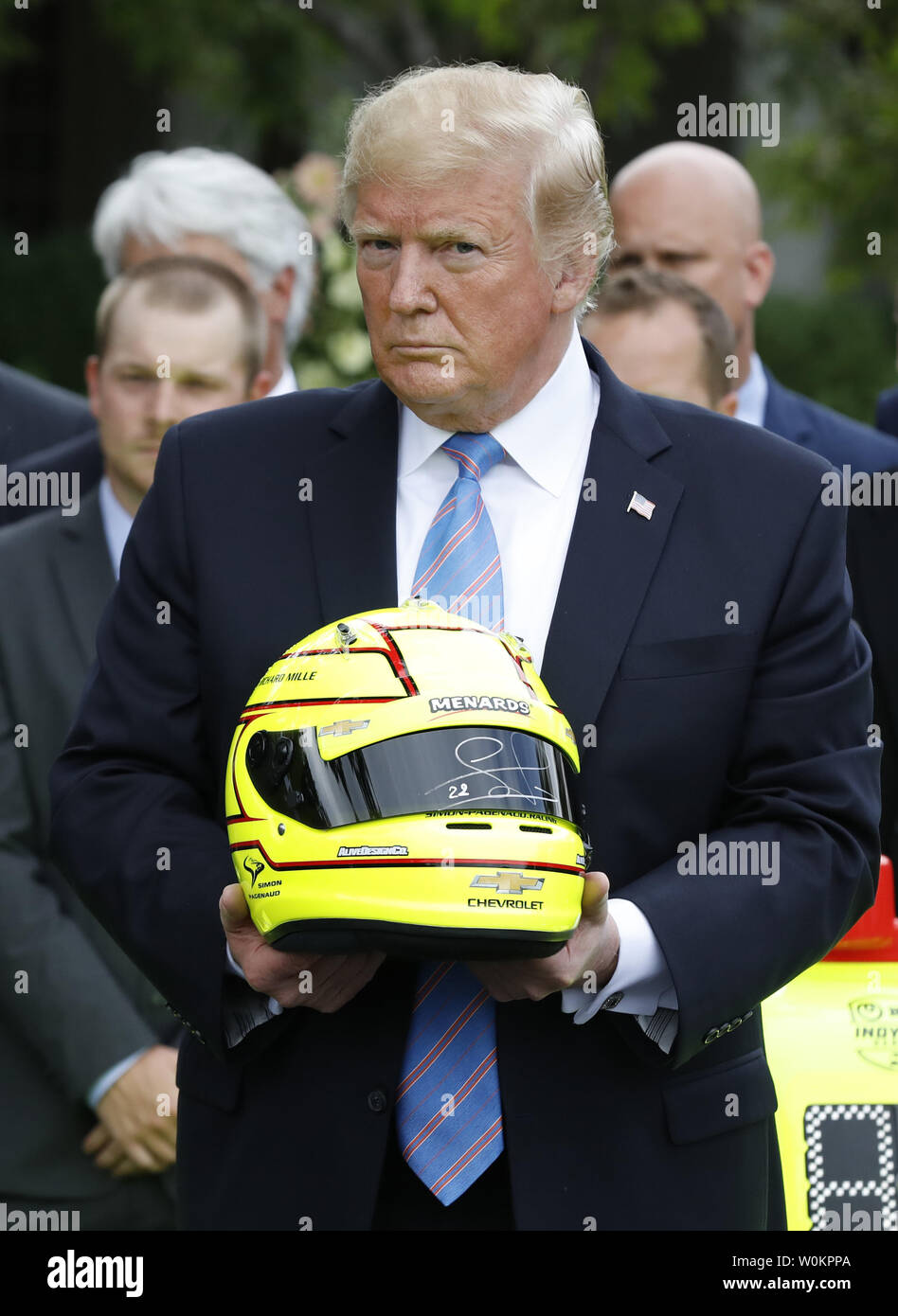 U.S. President Donald Trump holds a souvenir helmet presented him by ...