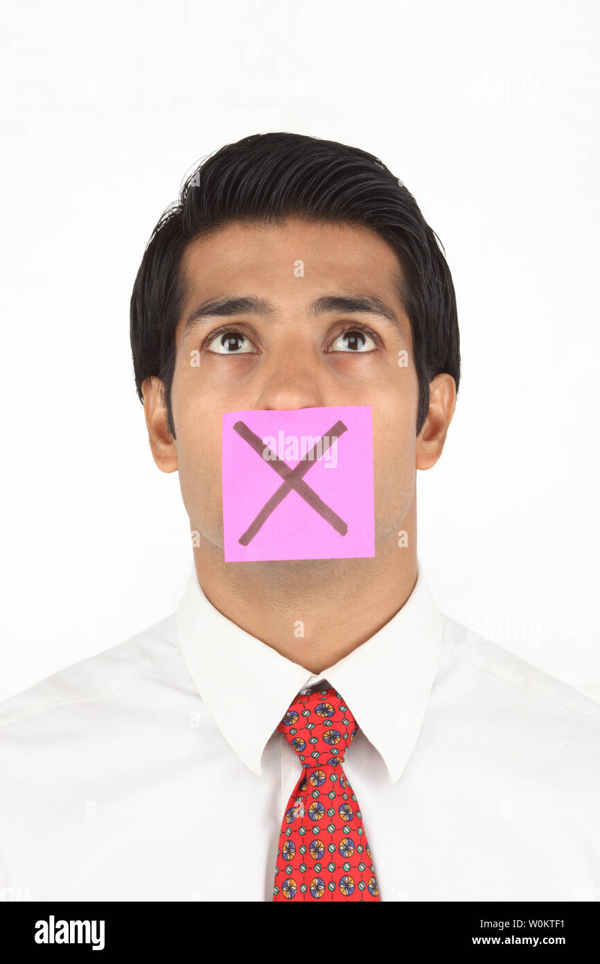 Businessman with adhesive note over his mouth Stock Photo - Alamy