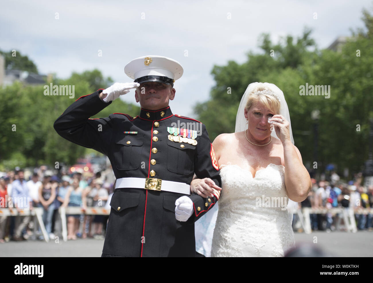 USMC SSgt. Tim Chambers salutes Rolling Thunder riders next to his ...
