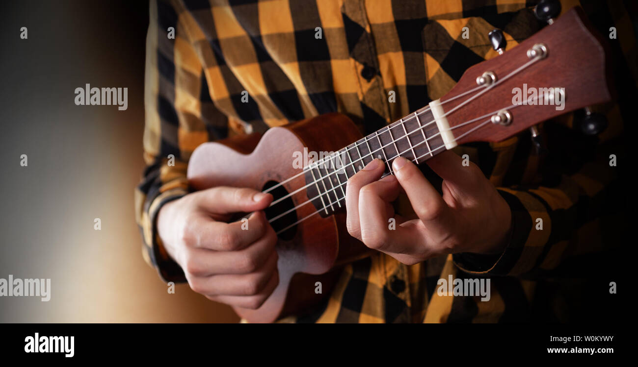 Person playing ukulele close up hi-res stock photography and images - Alamy