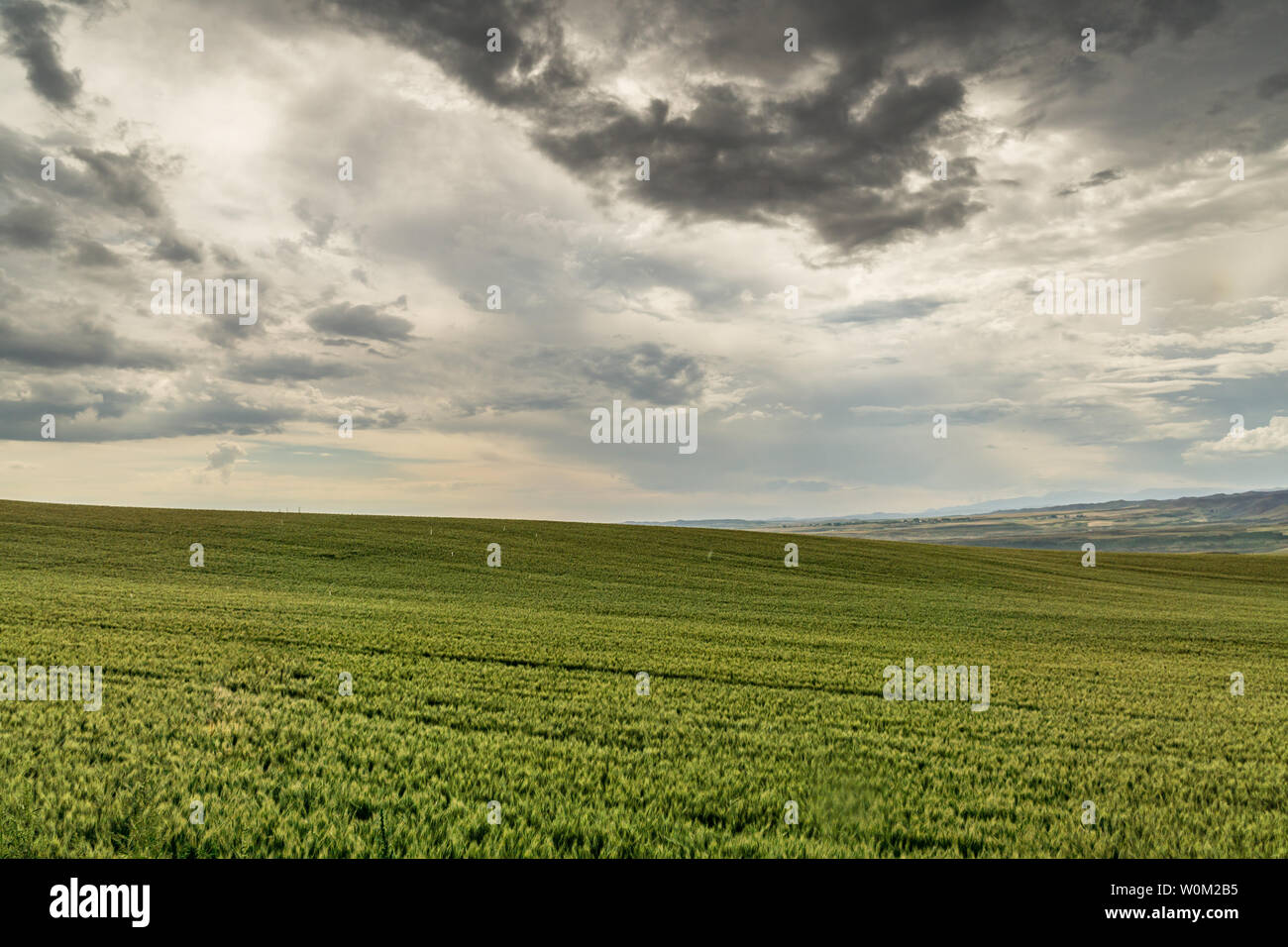 Hillside prairie villages under cloudy clouds Stock Photo - Alamy