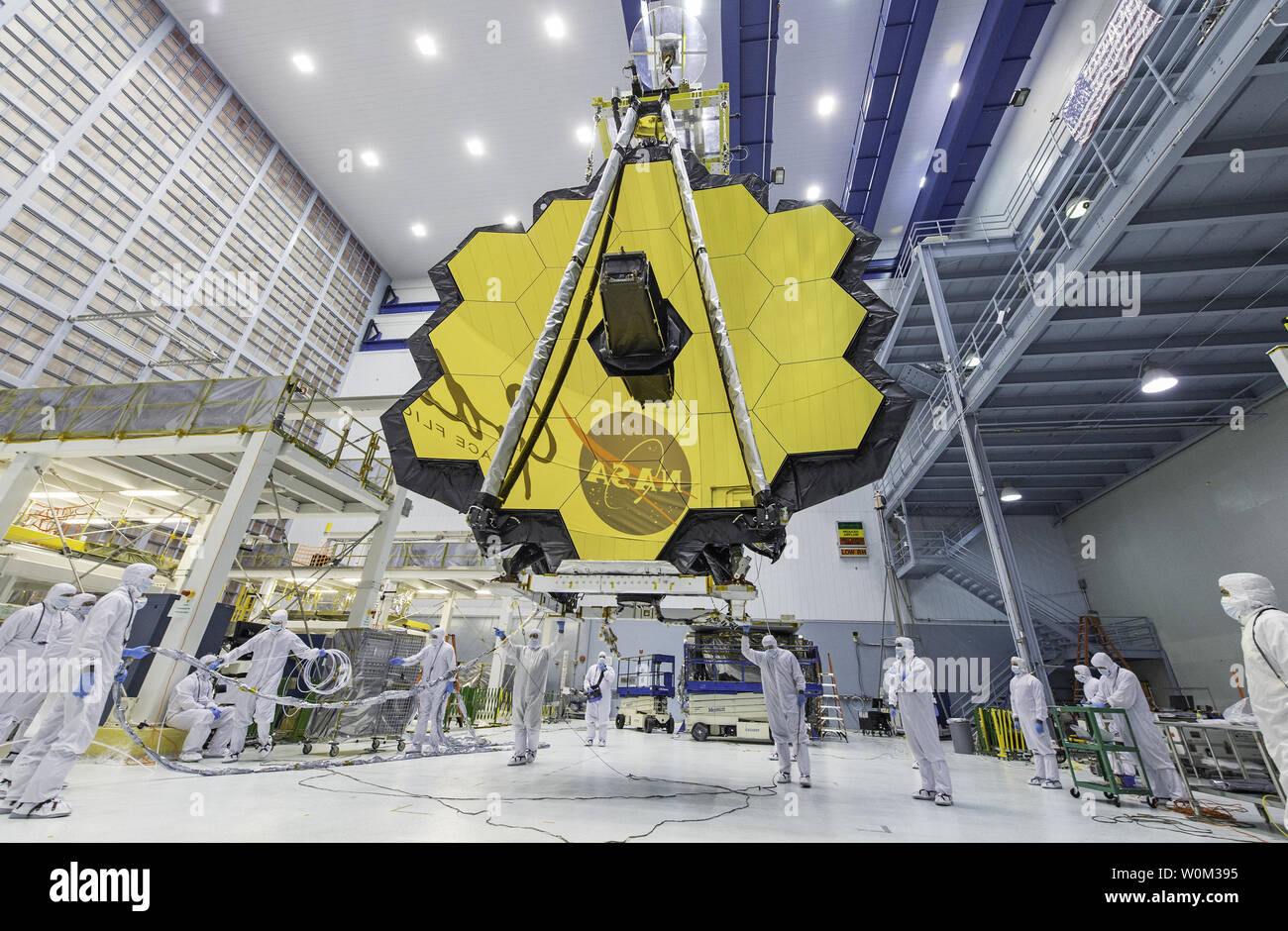 In this photo, released on April 25, 2017, NASA technicians lift the ...
