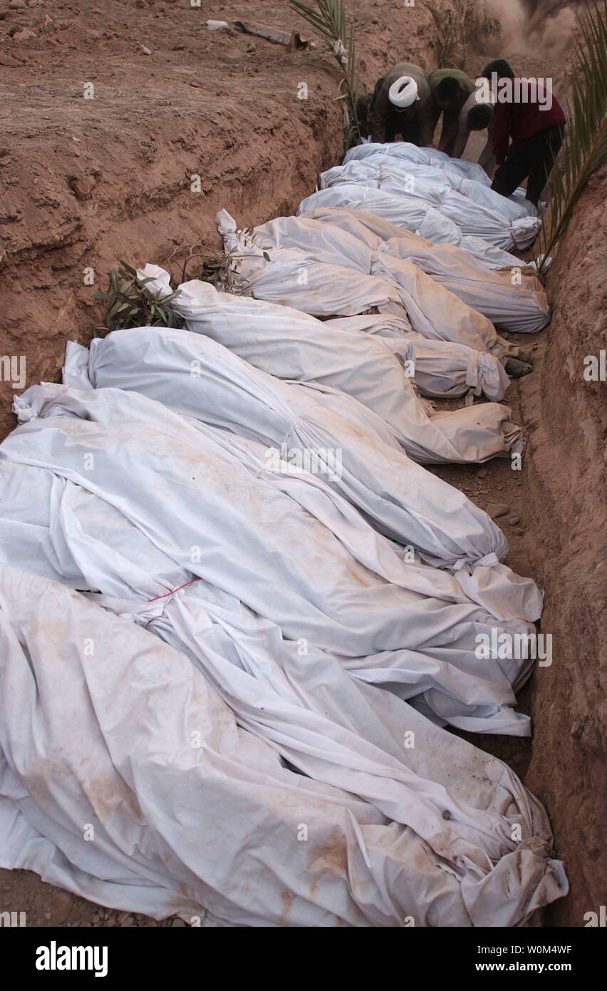 Bodies are buried in a mass grave after an earthquake in Bam, Iran ...
