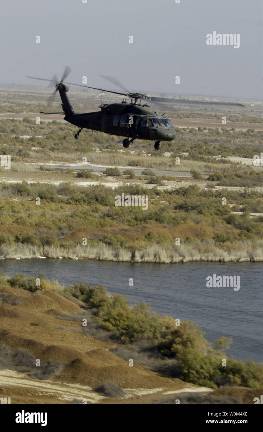 A UH-60L Blackhawk Helicopter flies a low-level mission over Iraq on ...