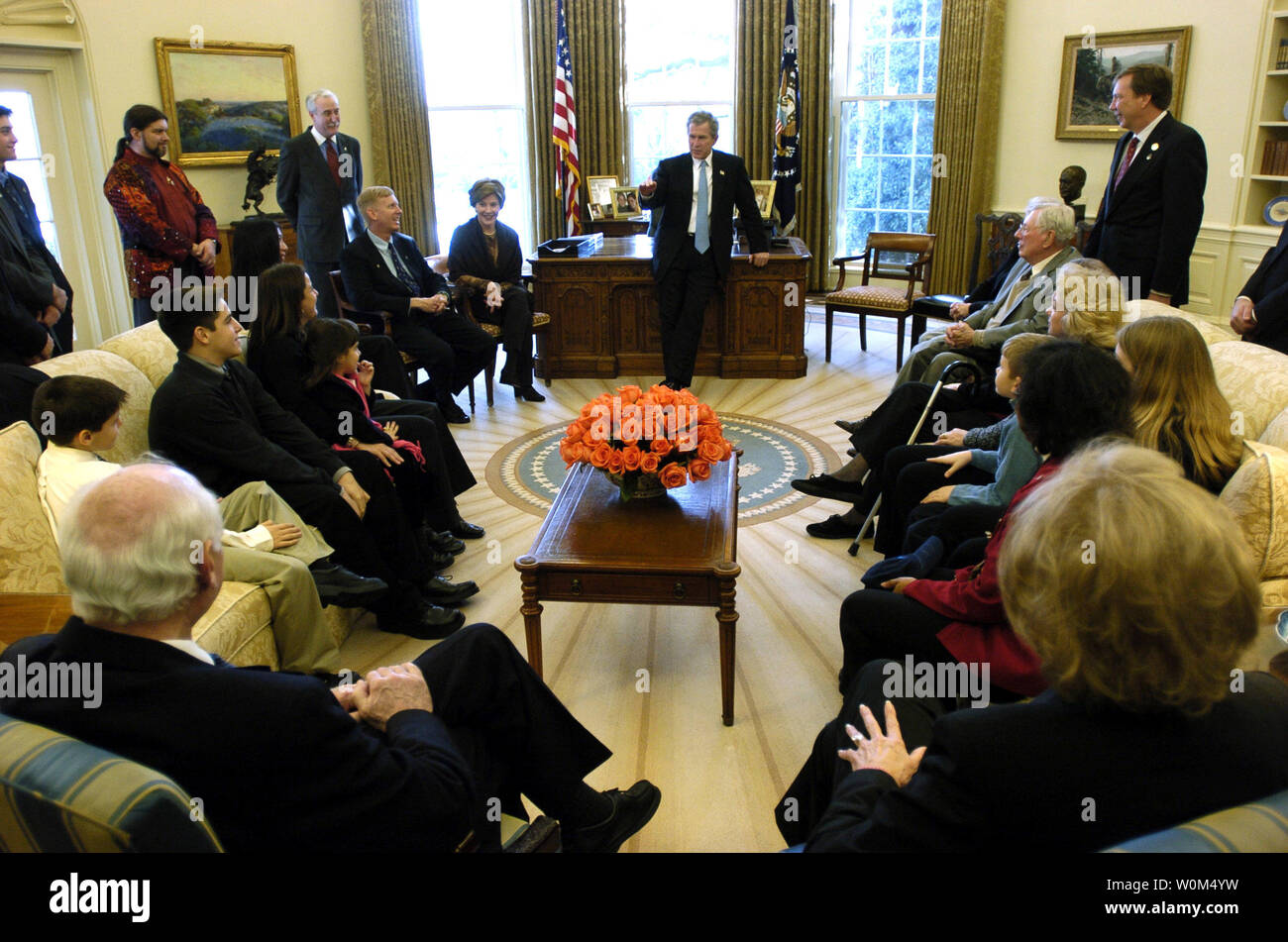 President George W. and Laura Bush speak with family members of the ...