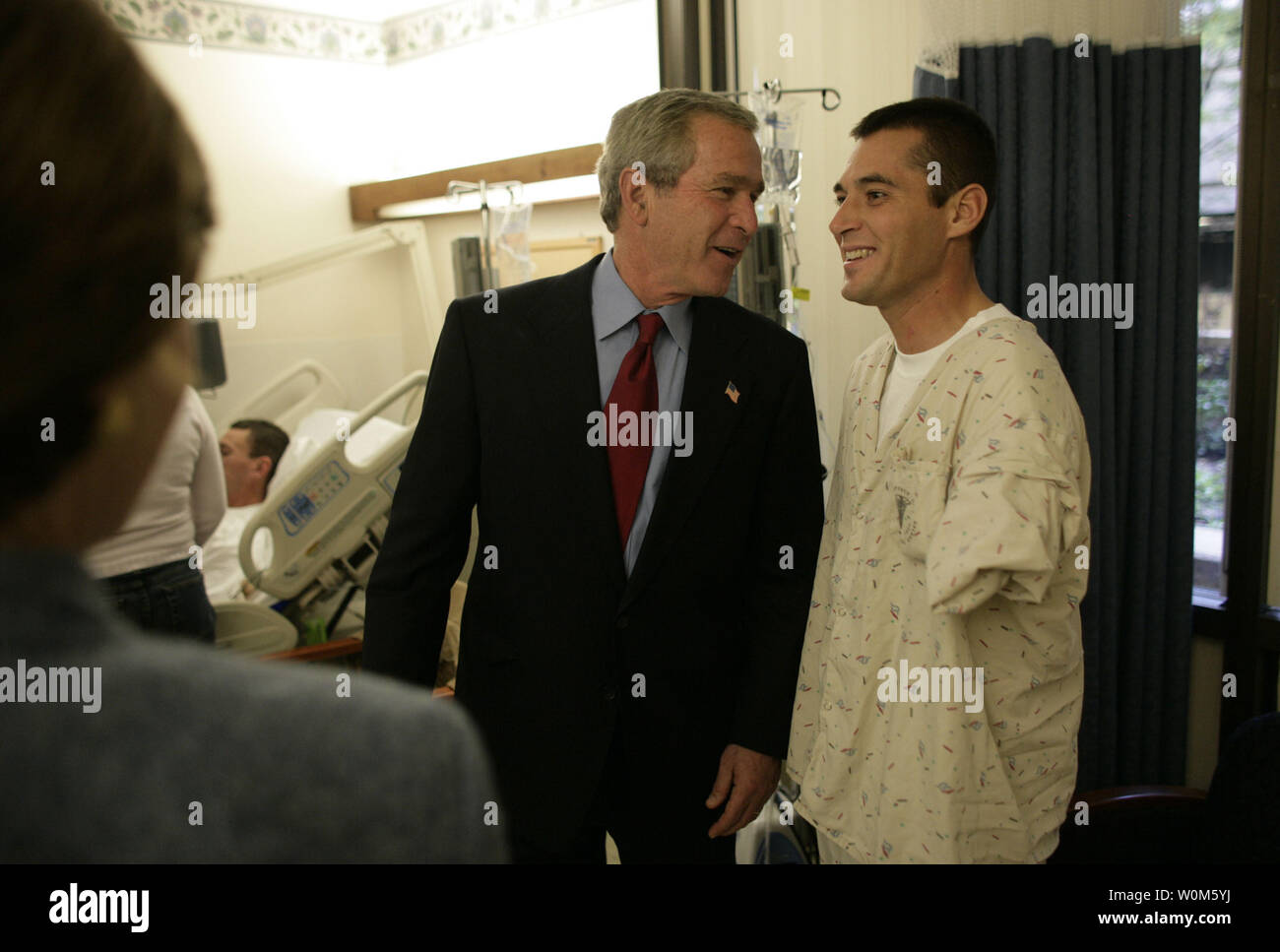 President George W. Bush talks with U.S. Army Spc. Kenneth Lukes of ...