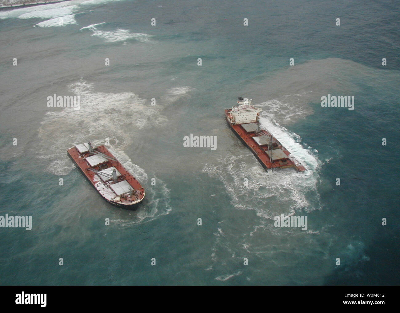 The two halfs of the Malaysian cargo ship Selendang Ayu sit offshore in ...