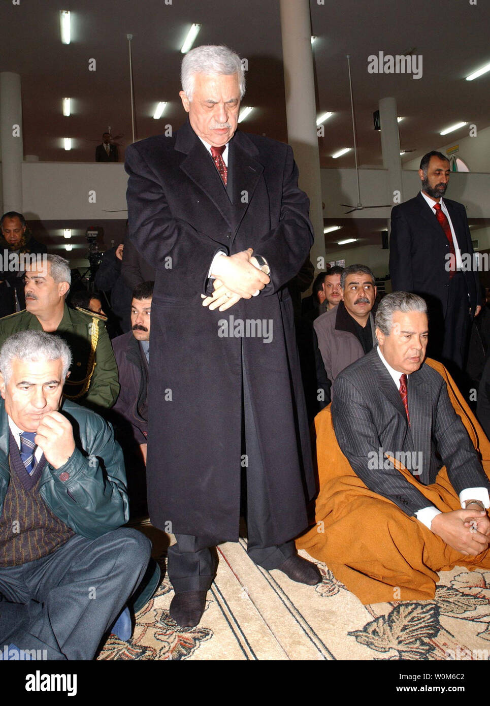 Palestinian President Mahmoud Abbas (C) prays in a mosque on the first ...