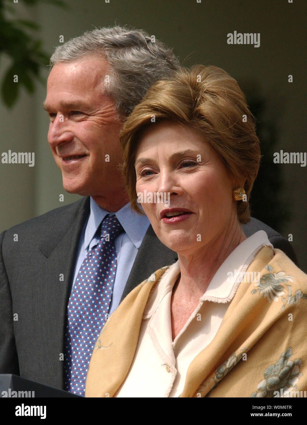President George W. Bush smiles as First Lady Laura Bush makes a few ...