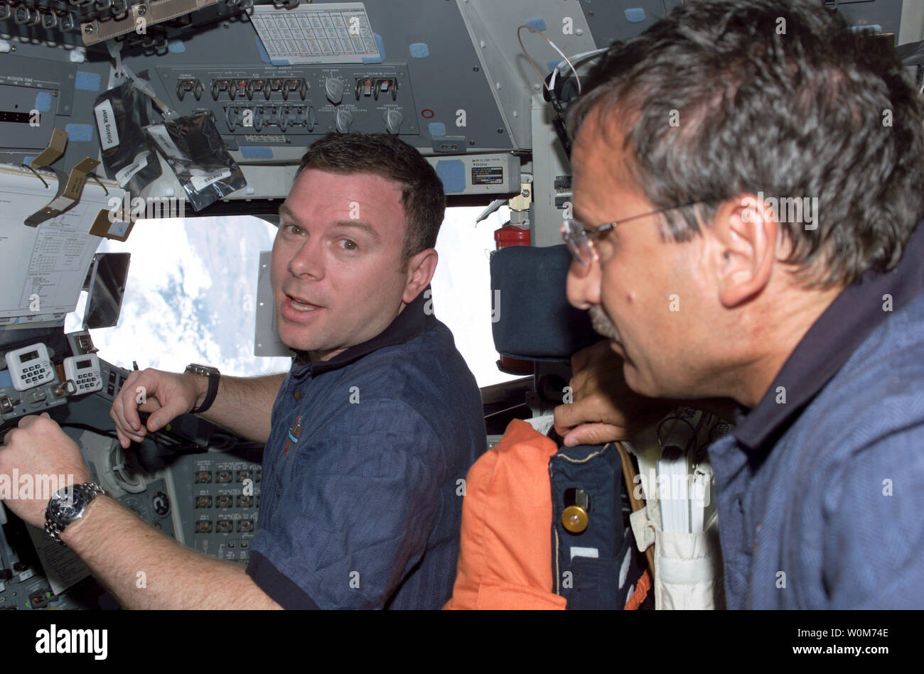 STS-114 Pilot Jim Kelly, left, talks with Mission Specialist Charlie ...