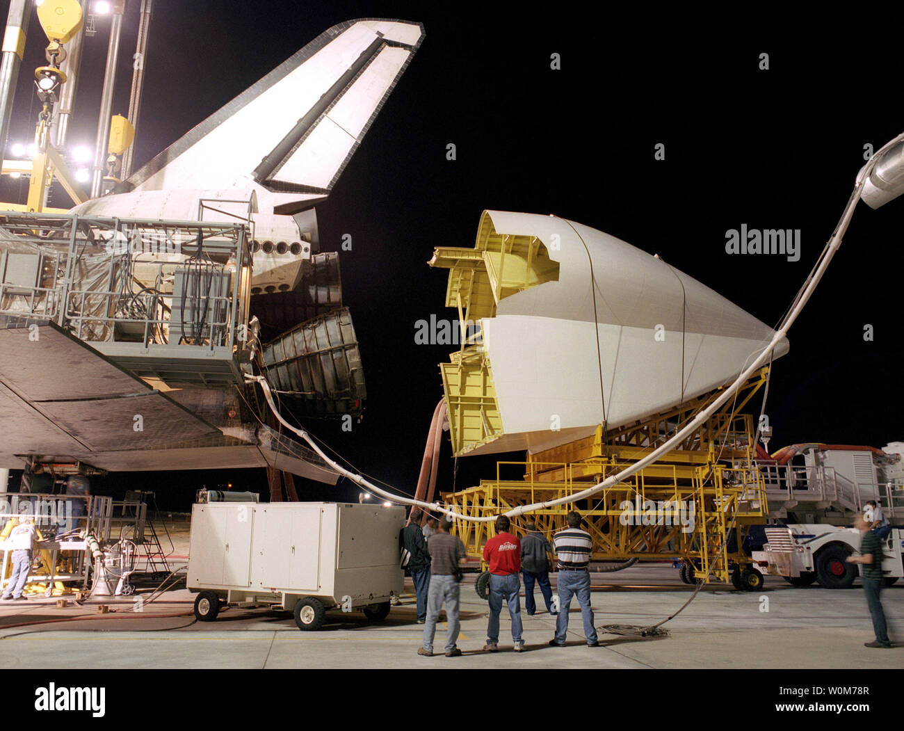 NASA technicians attach the tail cone to the Space Shuttle Discovery in ...