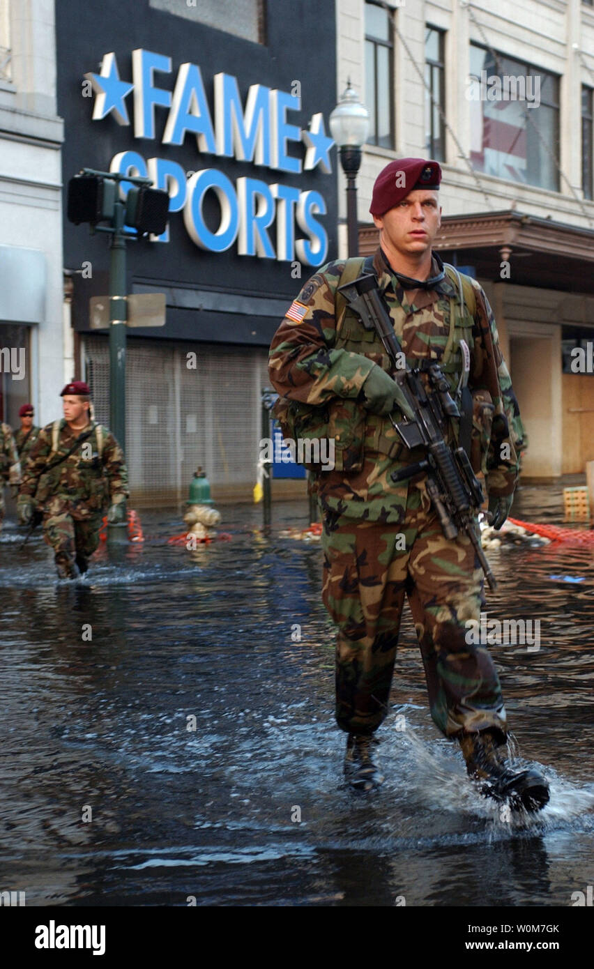 U.S. Army Sgt. Daniel Loeffler and his team wade through the flooded ...