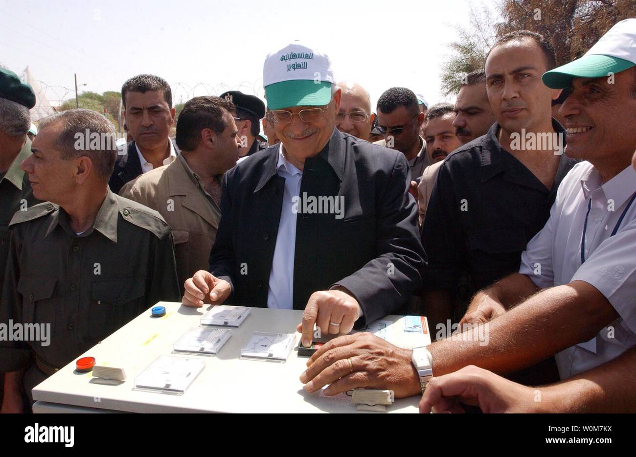 Palestinian President Mahmoud Abbas pushes the button to inaugurate the ...