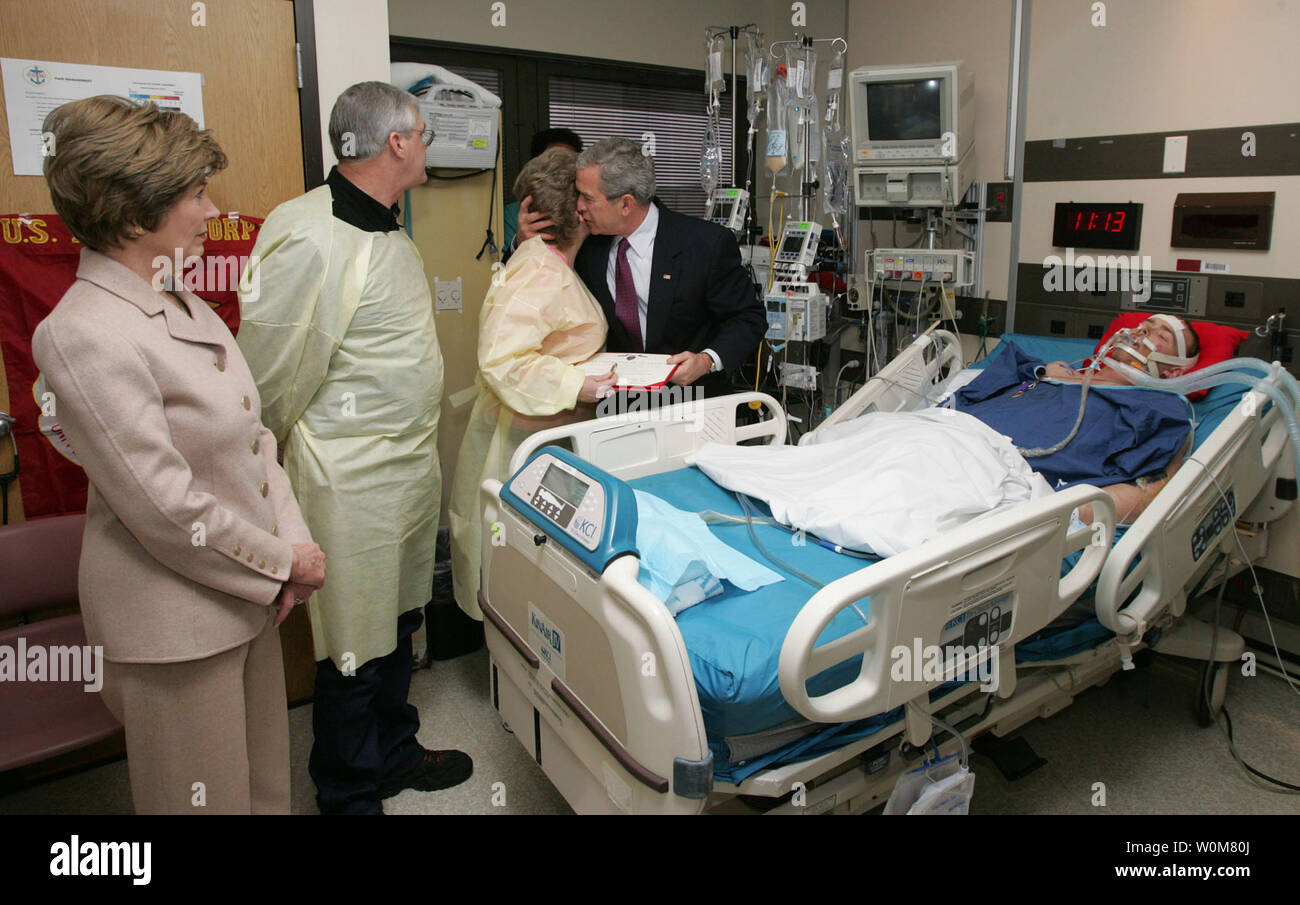 President George W. Bush embraces Sue Greene, mother of Cpl. Travis M ...