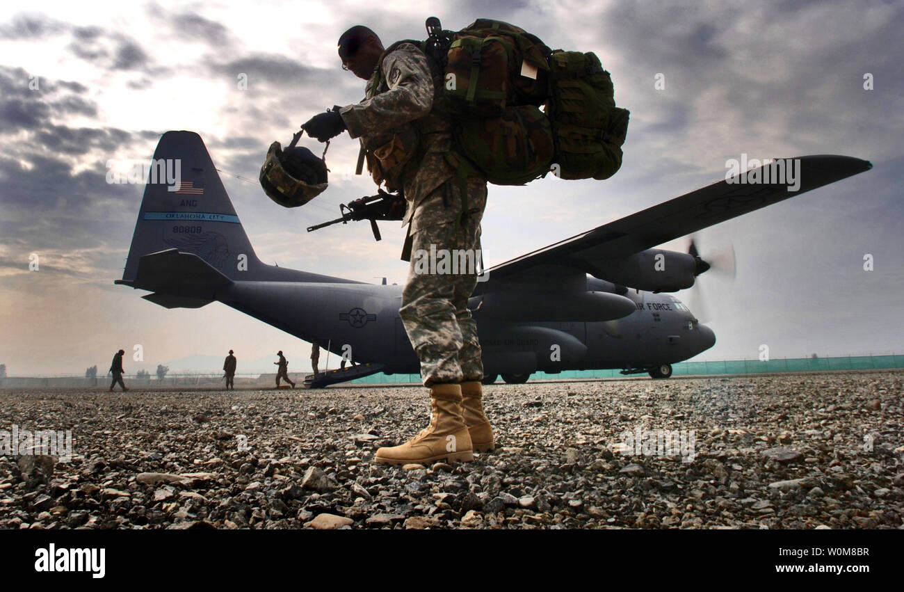 U.S. Army Sgt. 1st Class Ricky Bryant is last in line to board a C ...