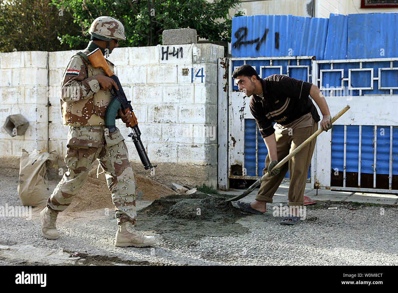 An Iraqi Army soldier greets a citizen in the town of Ubayde, Iraq, in ...