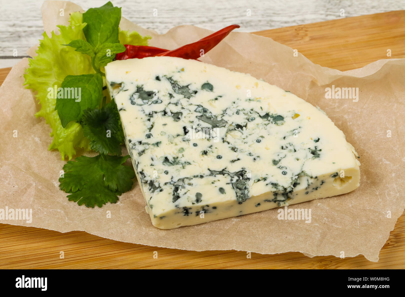 Blue cheese slice with salad leaves Stock Photo - Alamy