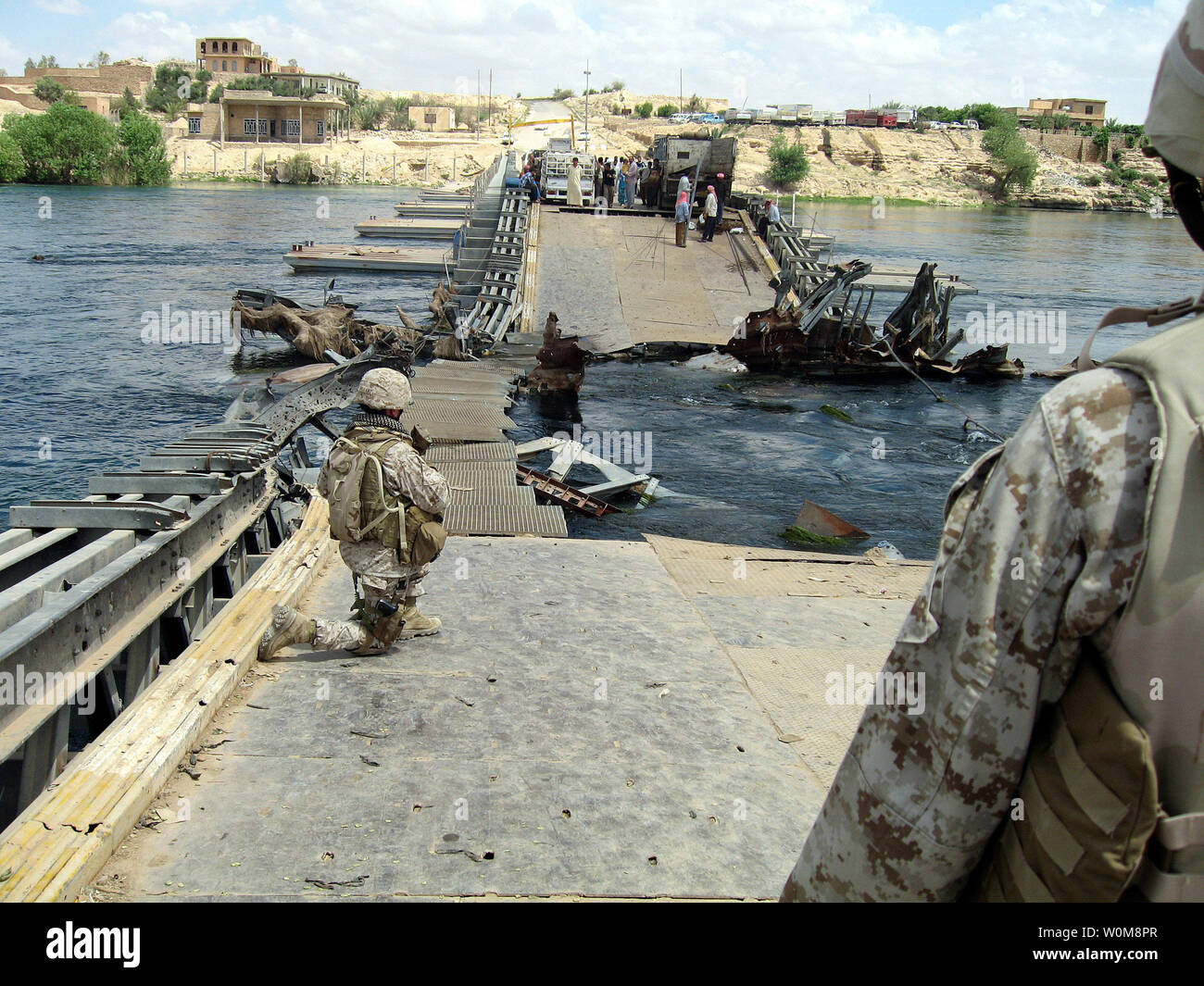 Marines survey a damaged bridge, in Haditha, Iraq on May 1, 2006. (UPI ...