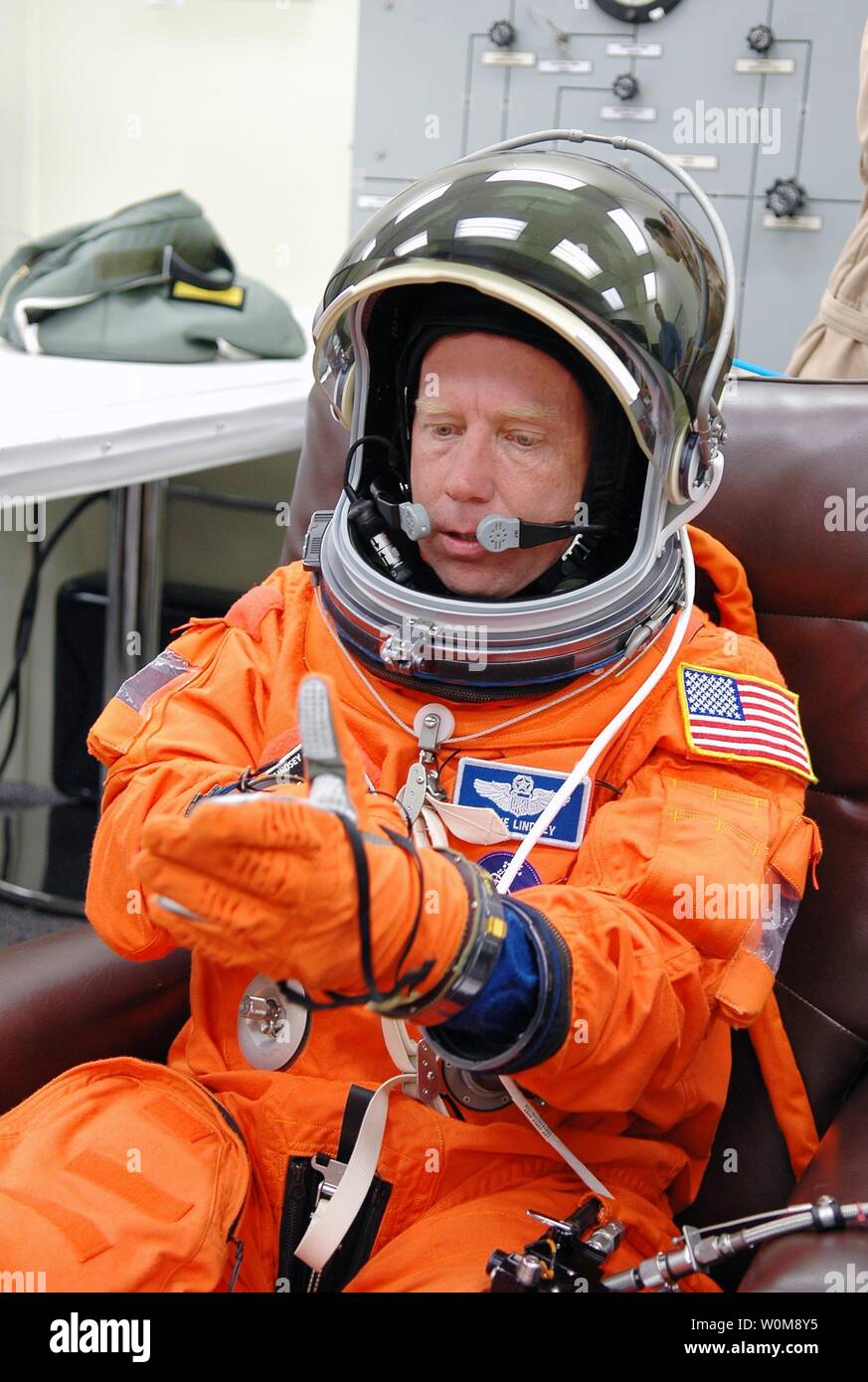 STS-121 Commander Steven Lindsey adjusts his glove as he dons his ...