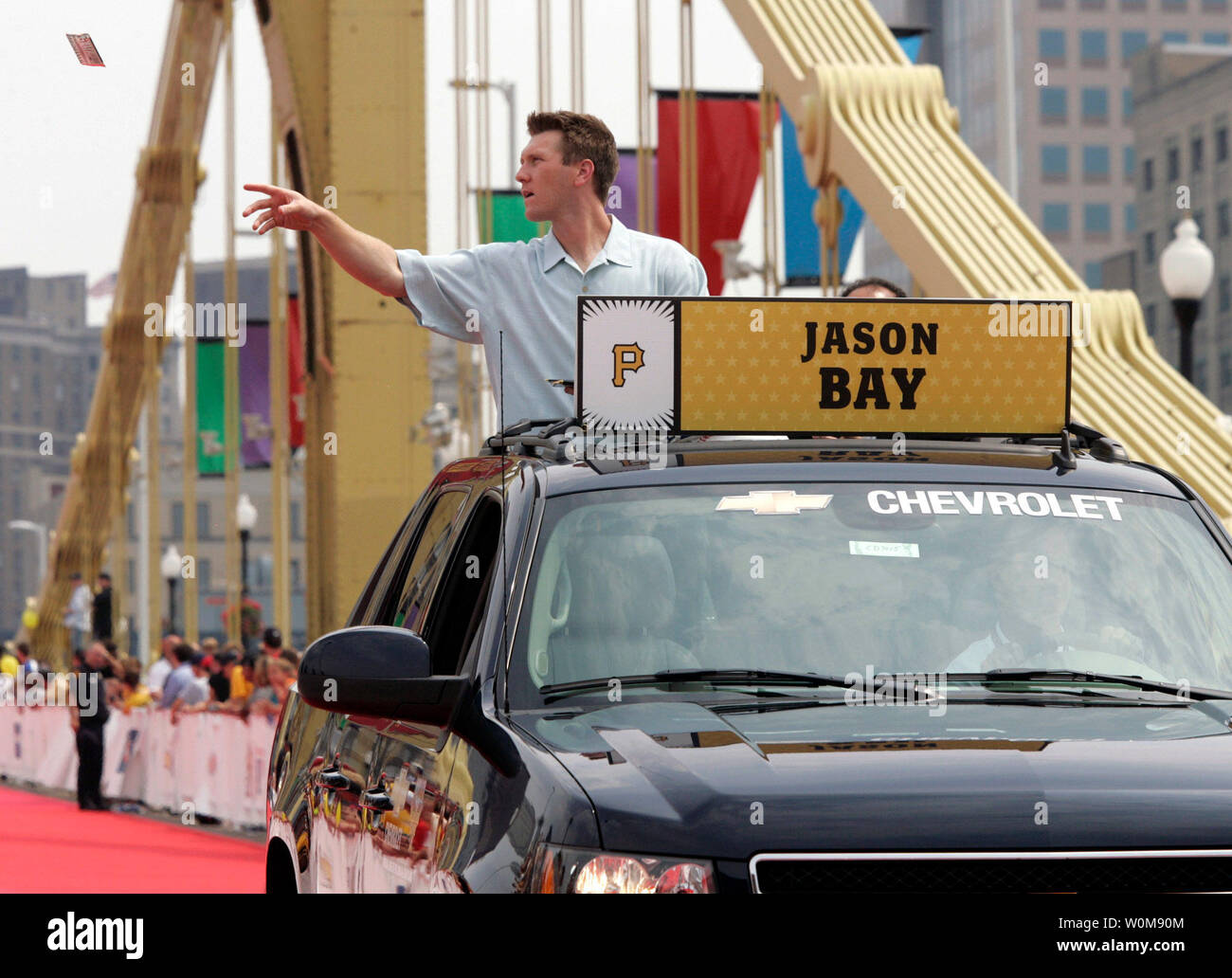 Jason Bay of the Pittsburgh Pirates throws candy to the crowd lining ...