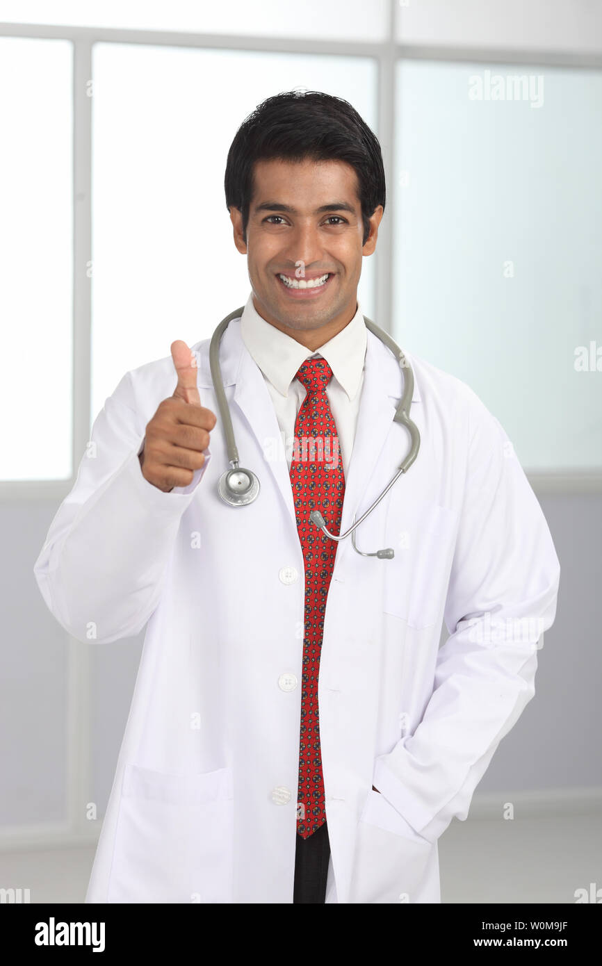 Male doctor showing thumbs up sign Stock Photo - Alamy