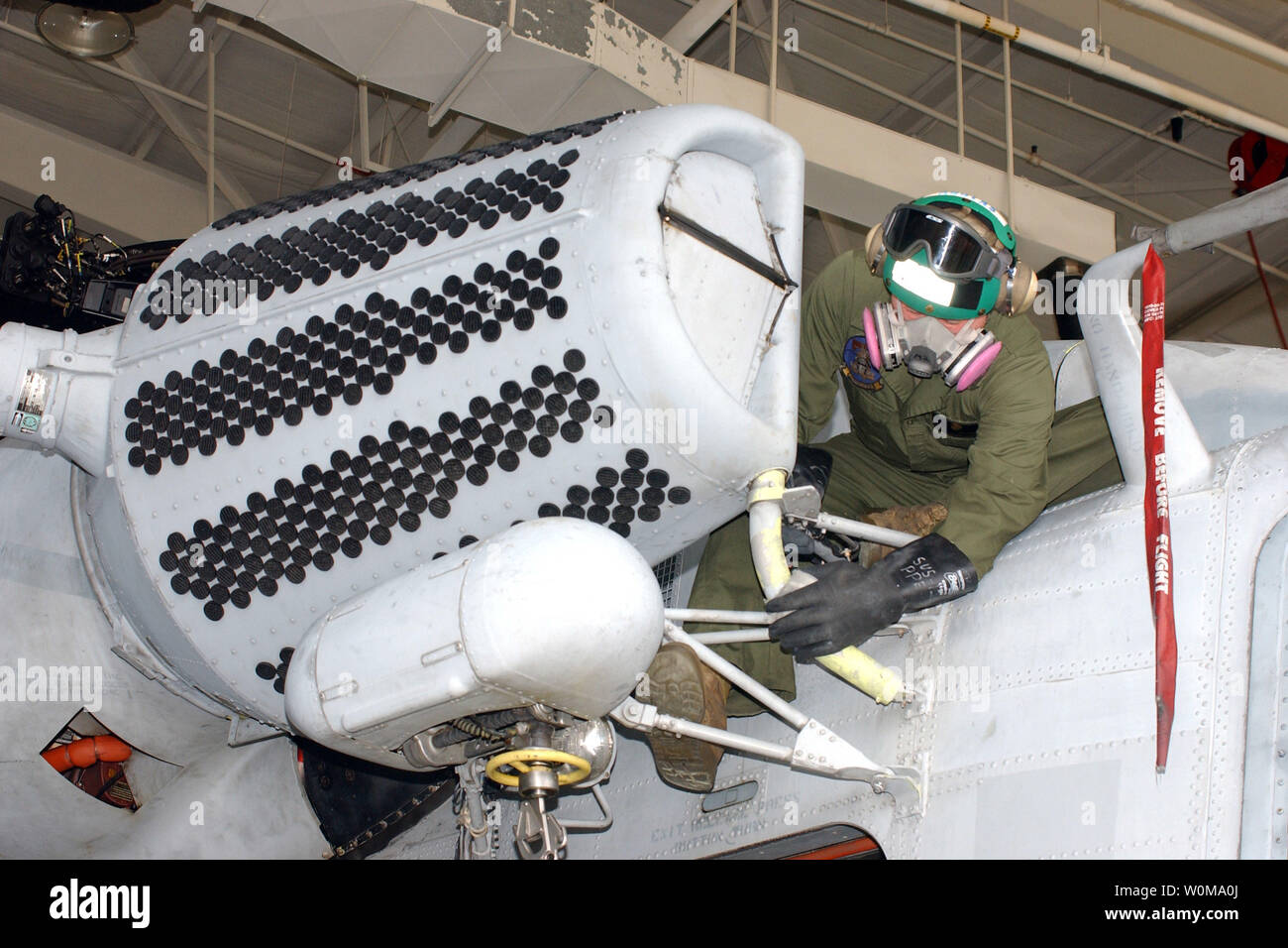 U. S. Marine Corps Staff Sgt. Ryan Williams sands an engine inlet ...