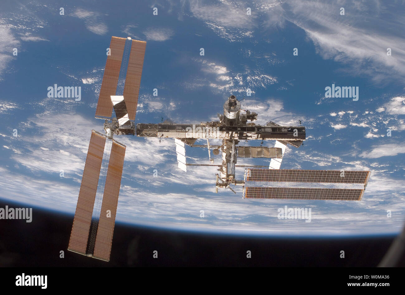 Backdropped by the blackness of space and Earth's horizon, the ...