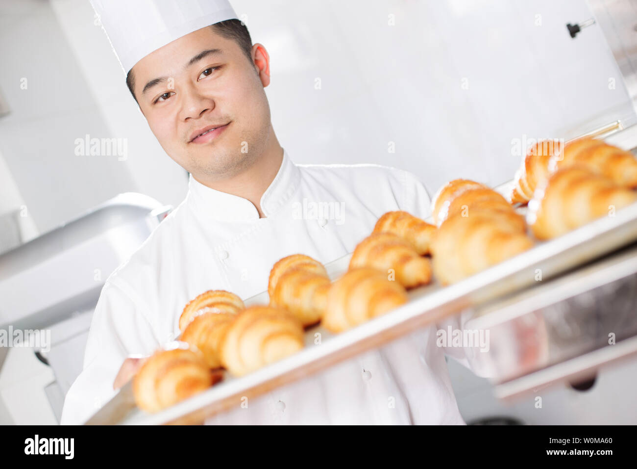 young chinese man chelf making bread in kitchen Stock Photo - Alamy