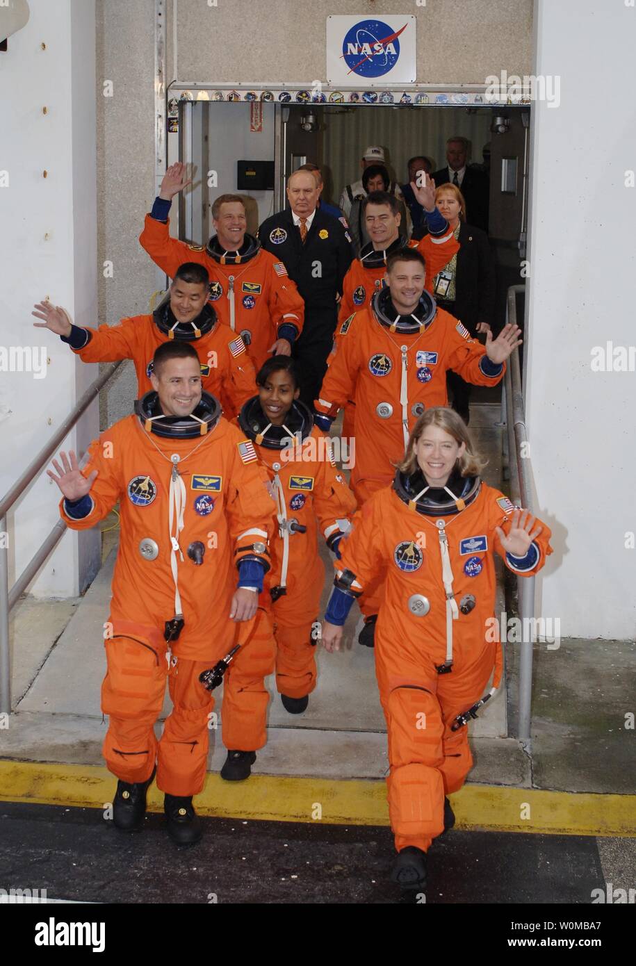 The STS-120 crew members walk out of the Operations and Checkout ...