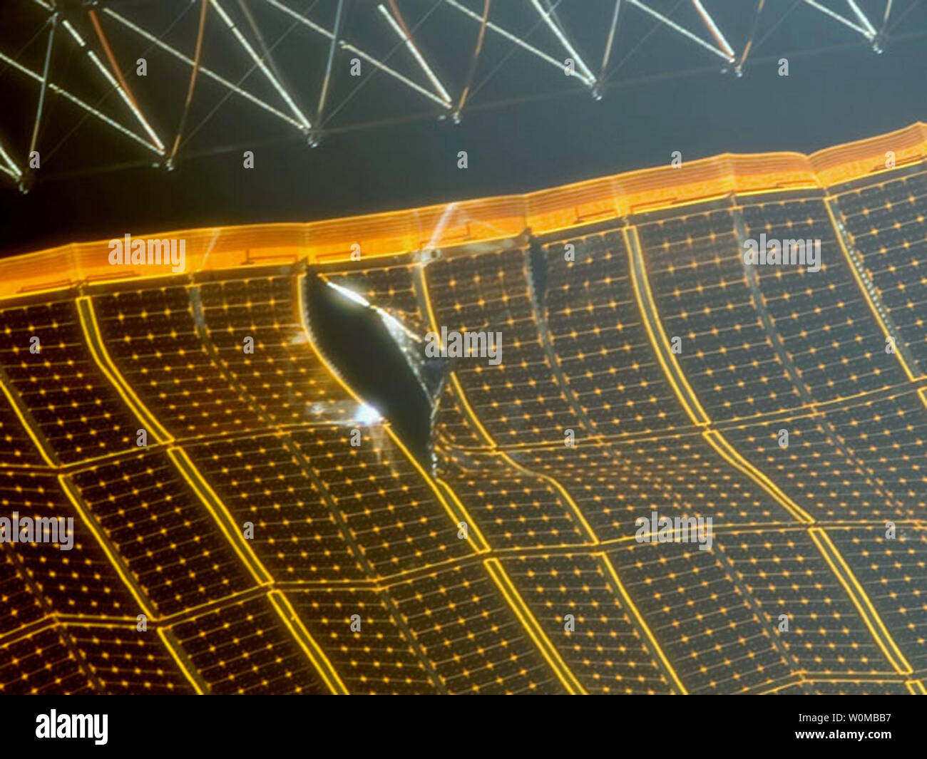 A NASA image shows damage to a solar array, which was ripped as ...