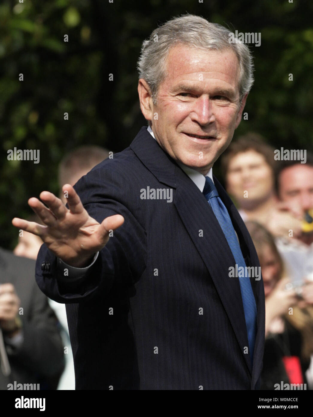 U.S. President George W. Bush waves as he walks out from the White ...