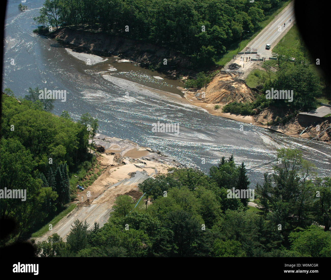 A road is washed out from the flooding of the Crawfish river in ...