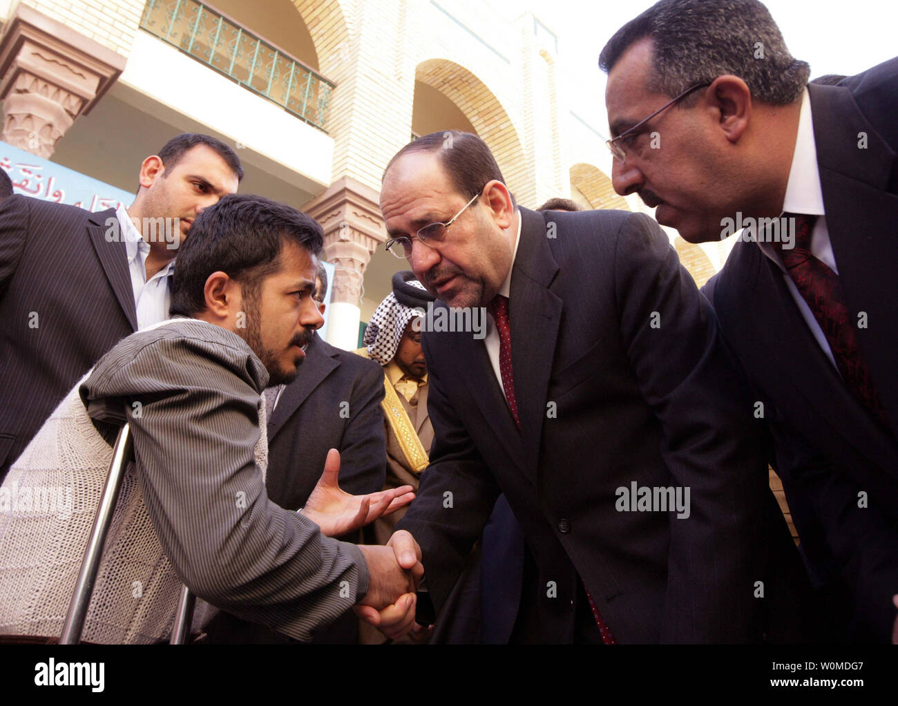 Iraqi Prime Minister Nouri al-Maliki talks to an Iraqi man during the ...