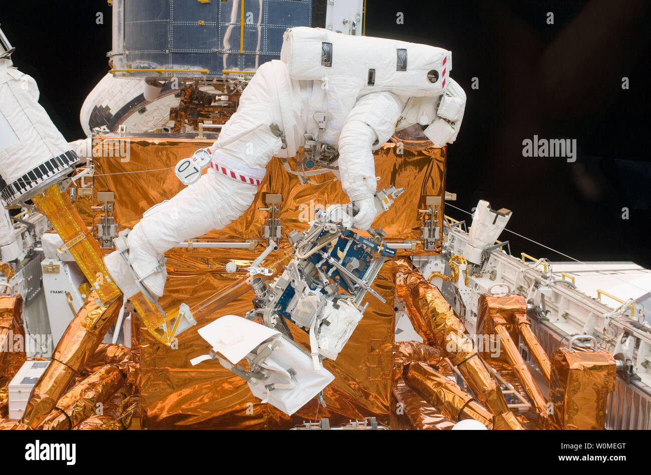 This NASA photo shows STS-125 Astronaut Michael Good working on the ...