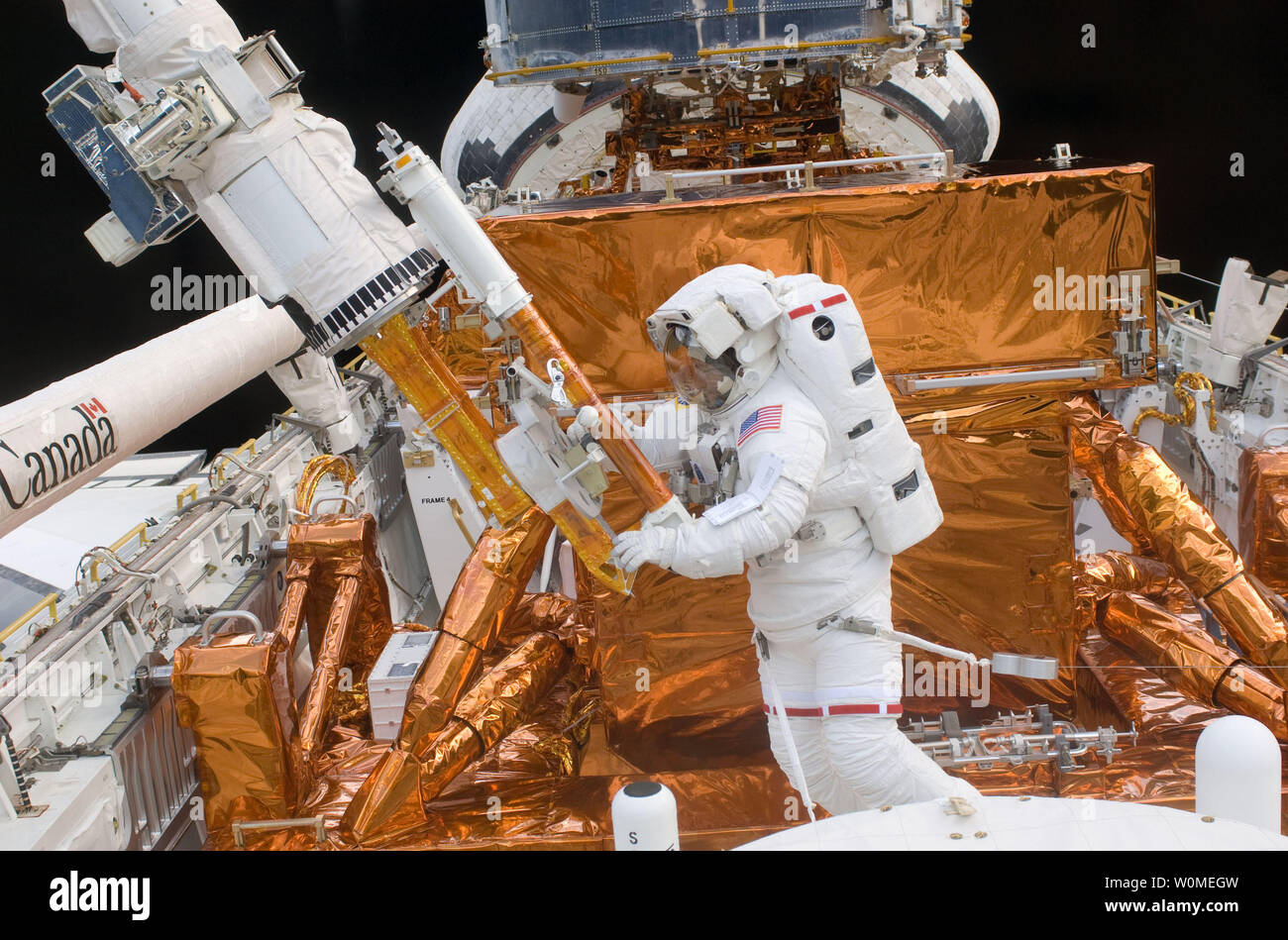 This NASA photo shows STS-125 Astronaut Mike Massimino working on the ...