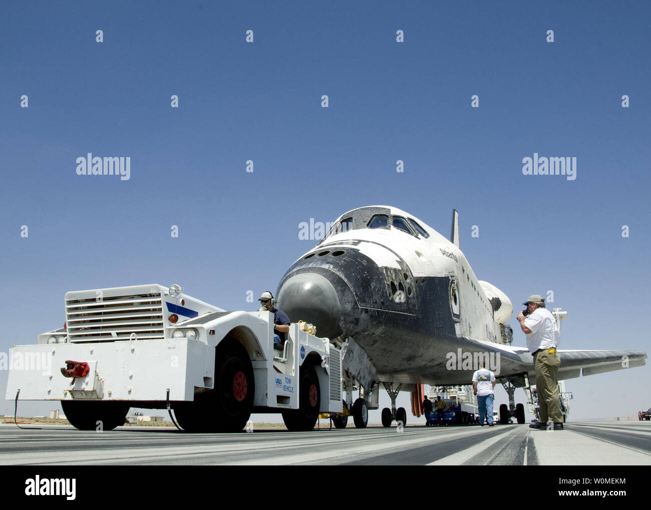 This NASA image shows Space Shuttle Atlantis being towed after landing ...