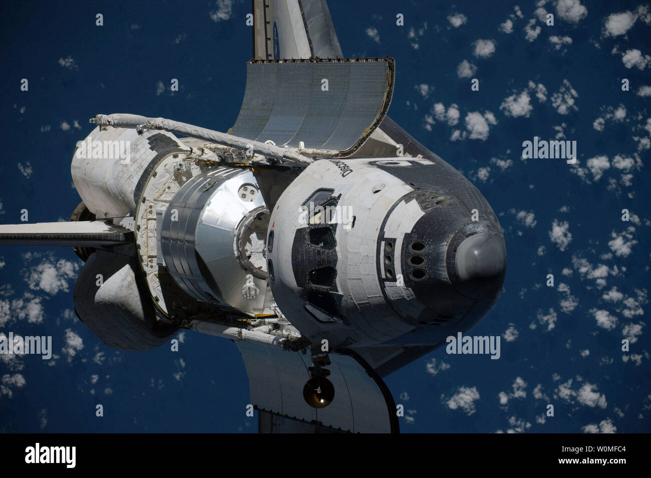 The Space Shuttle Discovery is seen as it performs a full 360-degree ...